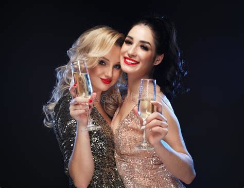 Two Glamour Women In Luxury Glitter Sequins Dress Drinking Champagne