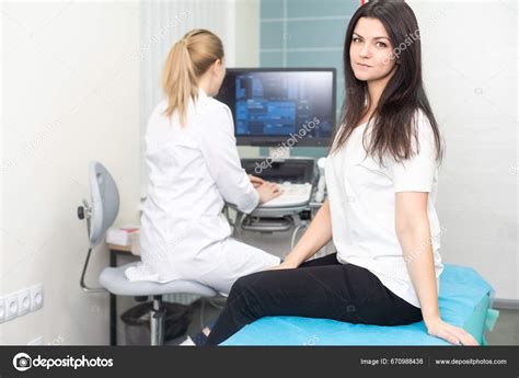 Doctor Using Ultrasound Scanning Machine Examining Thyroid Woman