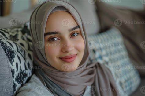 Ai Generated Portrait Of Attractive Young Woman With Hijab Smiling To Camera While Sitting On