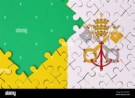 Vatican City State Flag Is Depicted On A Completed Jigsaw Puzzle With Free Green Copy Space On