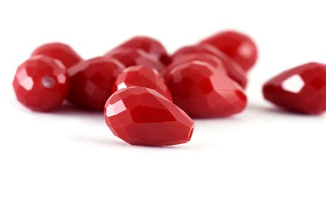 흰색 배경에 펼쳐진 빨간색 구슬을 놓습니다 구슬의 배경 또는 질감 클로즈업 마무리 패션 의류에 사용 비드 목걸이 또는 패션 여성을위한 구슬의 문자열을 확인 비드 크로 셰