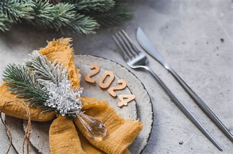 테이블 세팅 회색 배경에 세련된 접시 냅킨 유리 샴페인 크리스마스 트리 가지 크리스마스 장식 메리 크리스마스와 2024년 새해의 컨셉 0명에 대한 스톡 사진 및 기타 이미지