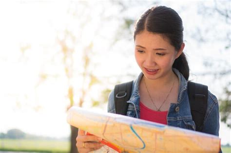 Premium Photo Young Woman Reading Map