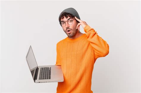 Premium Photo Nerd Man With Computer Looking Surprised Open Mouthed Shocked Realizing A New