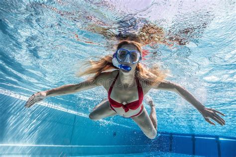 Woman In Snorkeling Mask Dive Underwater In Swimming Pool Of A Spa