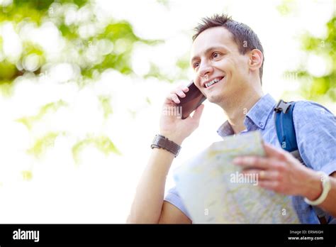 Man Holding Map Outdoors And Talking By Phone Stock Photo Alamy