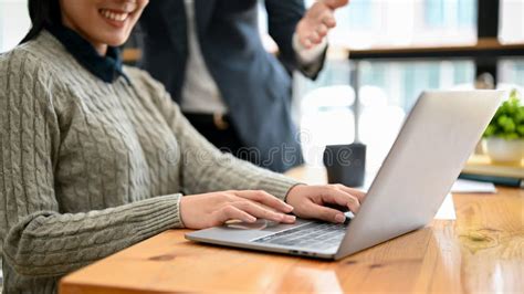 Cropped Image Of A Beautiful Young Asian Female Assistant Using Her
