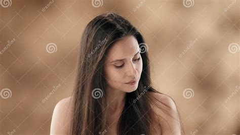 In The Frame Against A Blotchy Background Is A Middle Aged Woman With