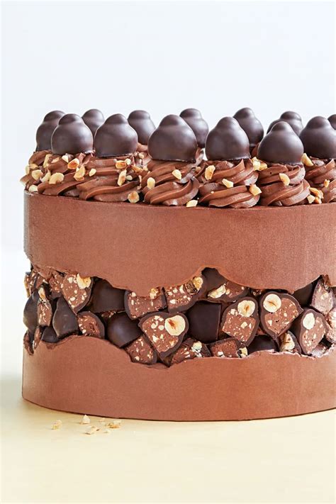 A Cake With Chocolate Frosting And Nuts On Top