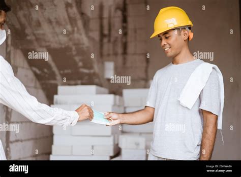 Construction Worker Given A Mask While Working On A Site Project Stock Photo Alamy