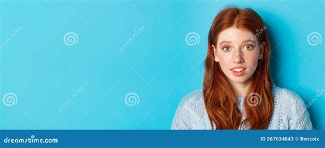 Headshot Of Cute Redhead Girl With Freckles Looking Hopeful And
