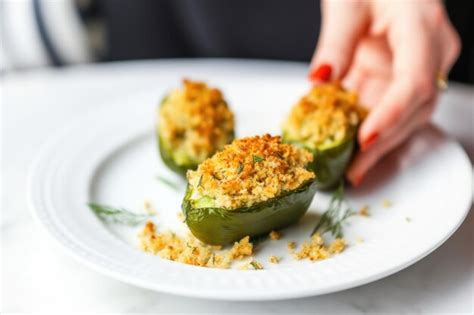 Premium Ai Image Handheld Stuffed Bell Pepper Bite Taken On White Plate