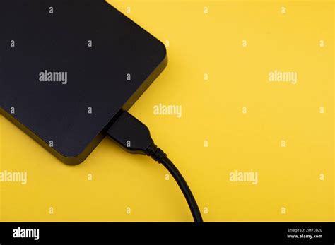 Black External Portable Hard Disk Drives Isolated On Yellow Background Stock Photo Alamy