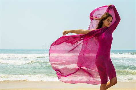 Sport Girl Teenager In A Pink Bathing Suit On Background Of Ocean