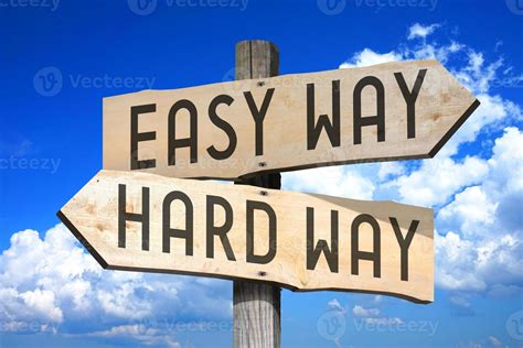 Easy Way Hard Way Wooden Signpost With Two Arrows Sky With Clouds