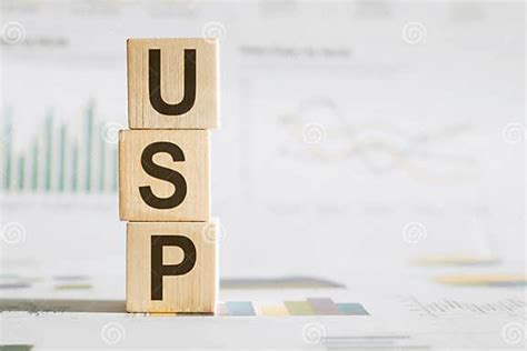 Wooden Blocks Stacked With Letters Usp Against A Blurred Chart