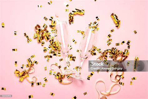 두 개의 빈 샴페인 잔과 옅은 분홍색 배경에 흩어져있는 황금 색종이 결혼식 컨셉 생일 기념일 파티 독신 파티 배너 결정체에 대한 스톡 사진 및 기타 이미지 Istock