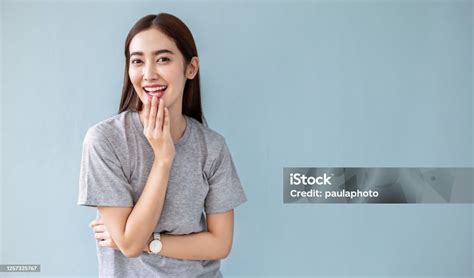 젊은 아름다운 아시아 한국의 수줍은 여자의 초상화 휴식 미소 행복 한 얼굴 패션 아시아 여자 보고 카메라 격리 된 블루 라이프 스타일 메이크업 아랍 빛 피부 미용 소녀 옆집