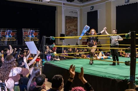 Female British Wrestler Celebrating Her Defense Victory During