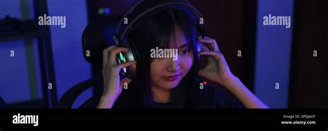 female cyber hacker gamer in headphone watching video game on monitor