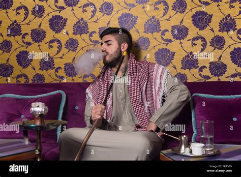 Muslim Man Smoking Shisha At Arabic Restaurant - Exhaling Smoke Stock ...