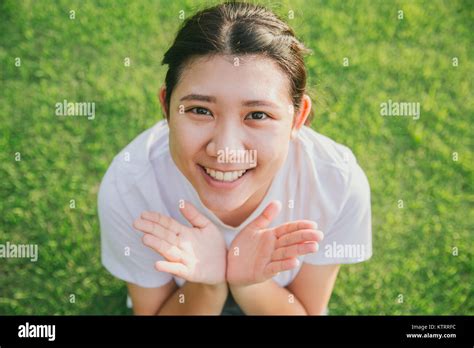 Cute Young Innocent Asian Teen Smile With Green Grass Background Stock