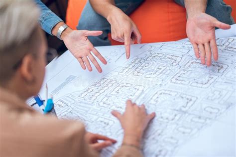 Group Of Draftspeople Working On A Drawing Stock Image Image Of