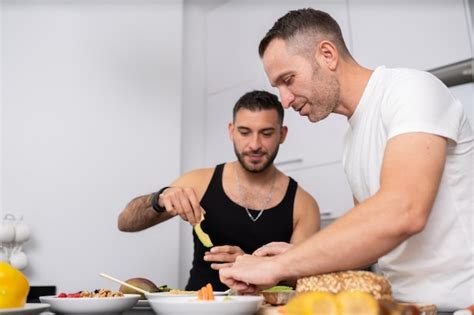 Premium Photo Gay Couple Preparing Food At Home