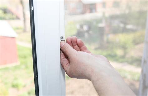 Premium Photo Man Is Installing The Mosquito Net On The Window Protection From Bugs