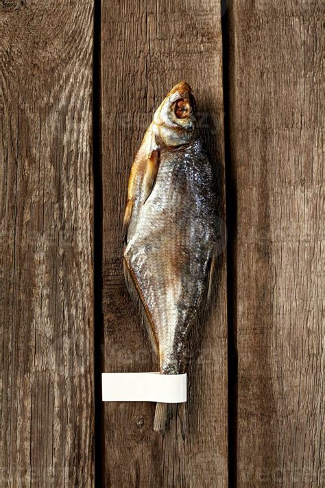 Salted Sun Dried Roach Fish With Label On Tail On Rough Wooden