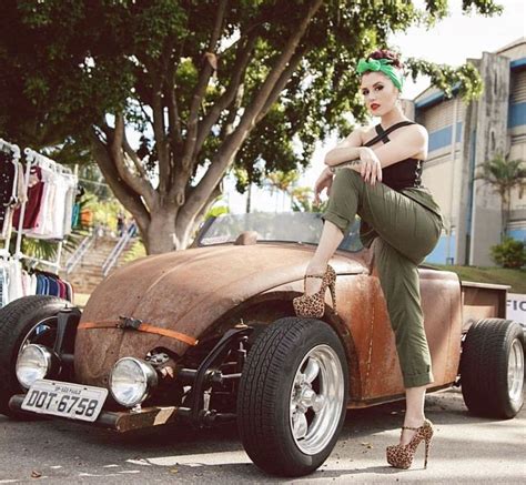 A Woman Sitting On Top Of An Old Car