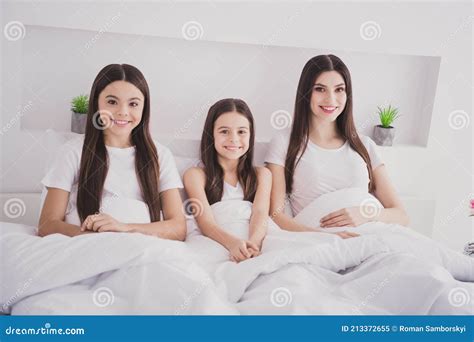 Photo Of Pretty Adorable Three Sisters Sleepwear Sitting Bed Having