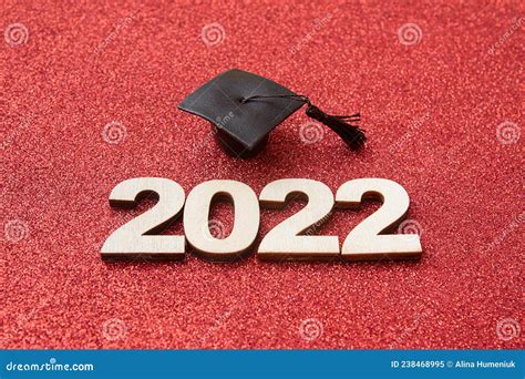 Graduat Hat With Wooden Number 2022 On Yellow Background Education