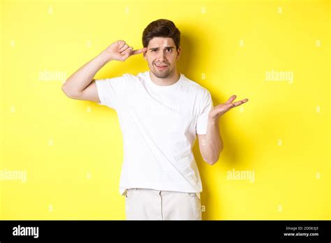 Confused And Angry Man Pointing At Head Scolding Person For Acting Stupid Show Crazy Sign