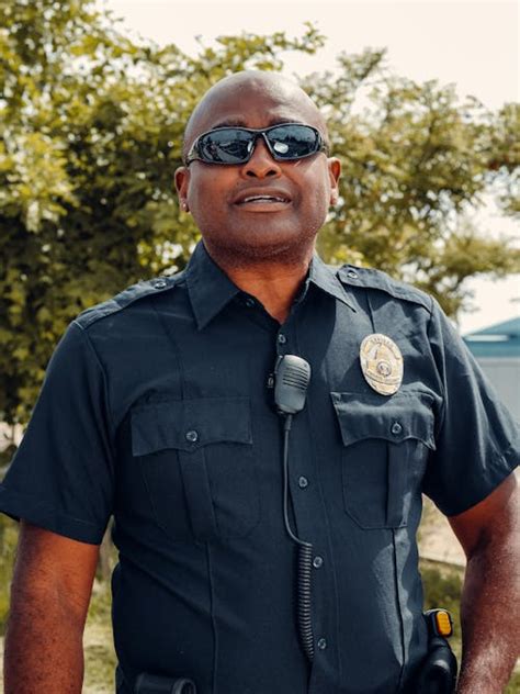 Close Up Shot Of A Police Officer Wearing Black Sunglasses · Free Stock