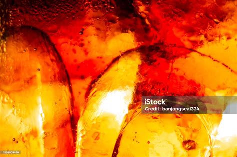 매크로 콜라 질감 매크로 청량 음료 질감 어두운 콜라 배경에 얼음 조각을 닫습니다 달콤한 여름 차가운 음료의 질감과 거품과 매크로 거품이 Fizzing 유리 벽에 있습니다