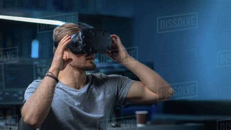 Software Delevoper Putting On Virtual Reality Headset On With His Head Developing And