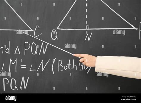 Female Teacher S Hand With Pointer Explaining Math Formulas On Blackboard Stock Photo Alamy