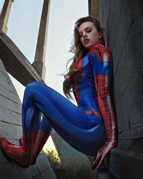 A Woman In Spider Man Costume Sitting On The Side Of A Building
