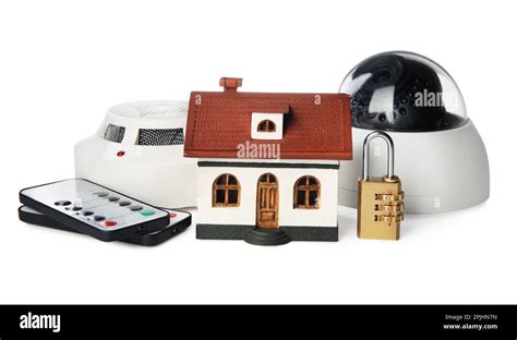 House Model Cctv Camera Remote Controls Lock And Smoke Detector On White Background Home
