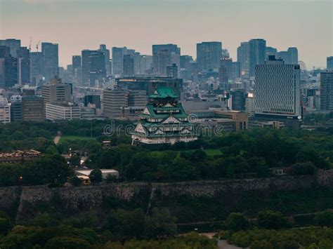 Aerial View Of Osaka Castle And Downtown Skyline Under Overcast Light
