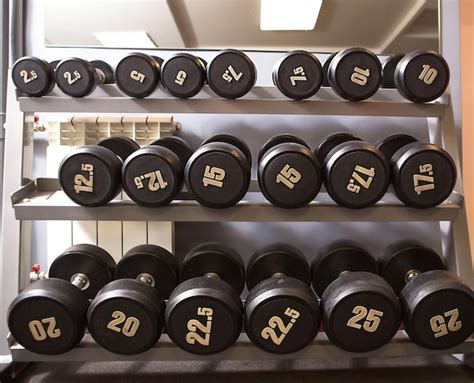 Premium Photo Dumbbells Of Different Weights With Numbers Are On A