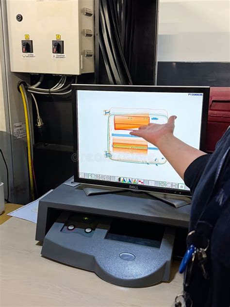 Asian Adult Demonstrating Industrial Control Panel In Technical Setting In Airport Editorial