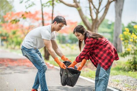 Free Photo Men And Women Help Each Other To Collect Garbage