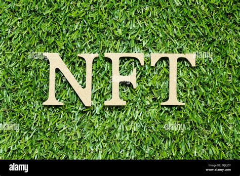 Wood Alphabet Letter In Word Nft Abbreviation Of Non Fungible Token On Green Grass Background