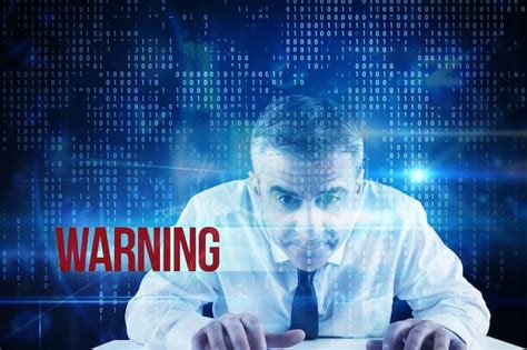 Premium Photo The Word Warning And Mature Businessman Typing On Keyboard Against Blue