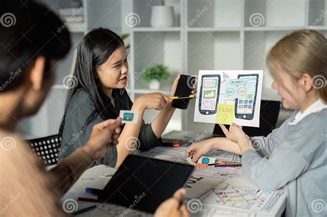 Creative Ux Ui Design Team Brainstorming Session With Digital Devices And Wireframes In Modern