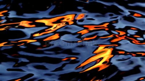 Rippling Water Surface Reflecting Fiery Orange Light In Abstract Pattern Vibrant And Dynamic