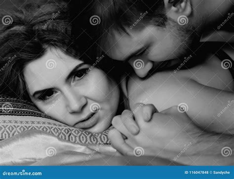Young Beautiful Loving Couple Is Embracing On A Bed Ntimate Image Of