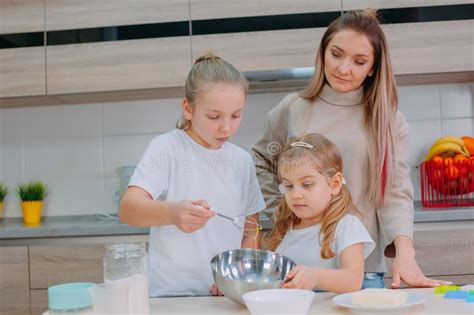 Mom Teaches Her Daughters To Make Dough In The Kitchen And Beat Eggs Stock Image Image Of Cook